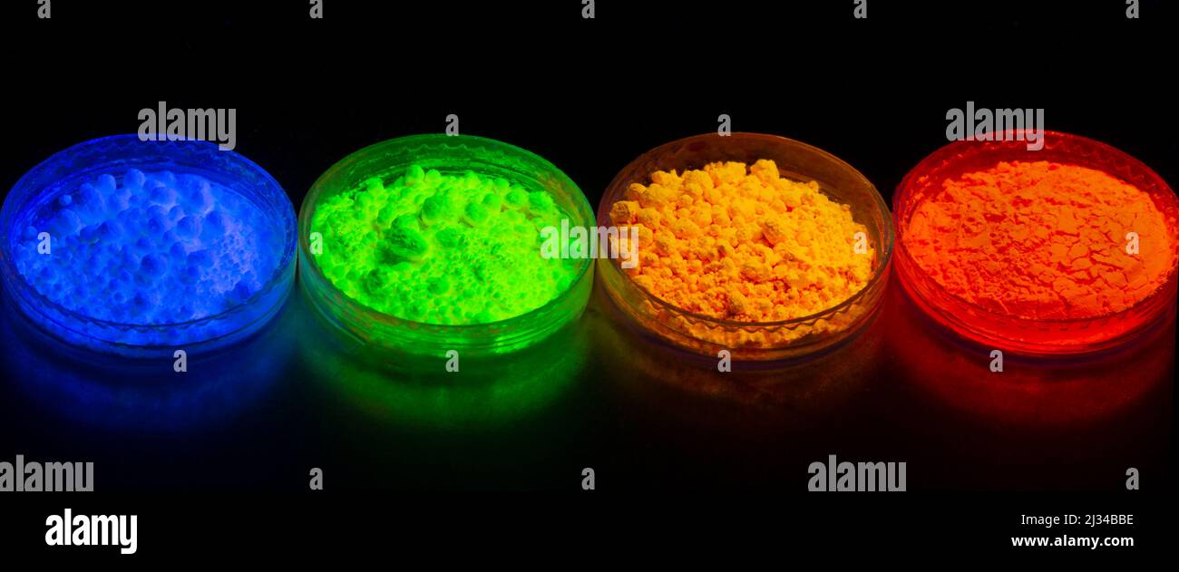 top view of colorful traditional holi powder in bowls isolated on dark ...