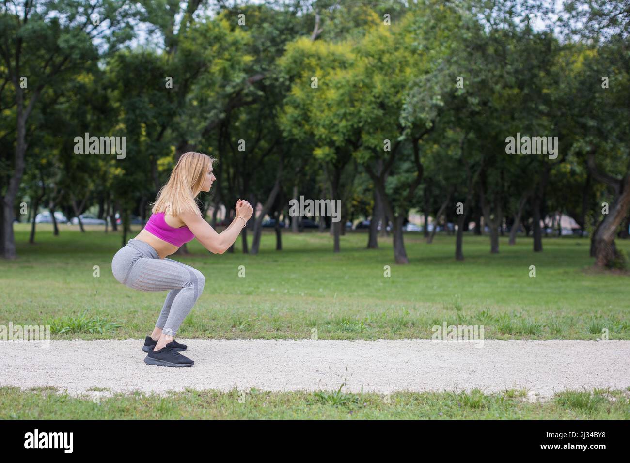 Caucasian female doing squats in hi-res stock photography and images ...