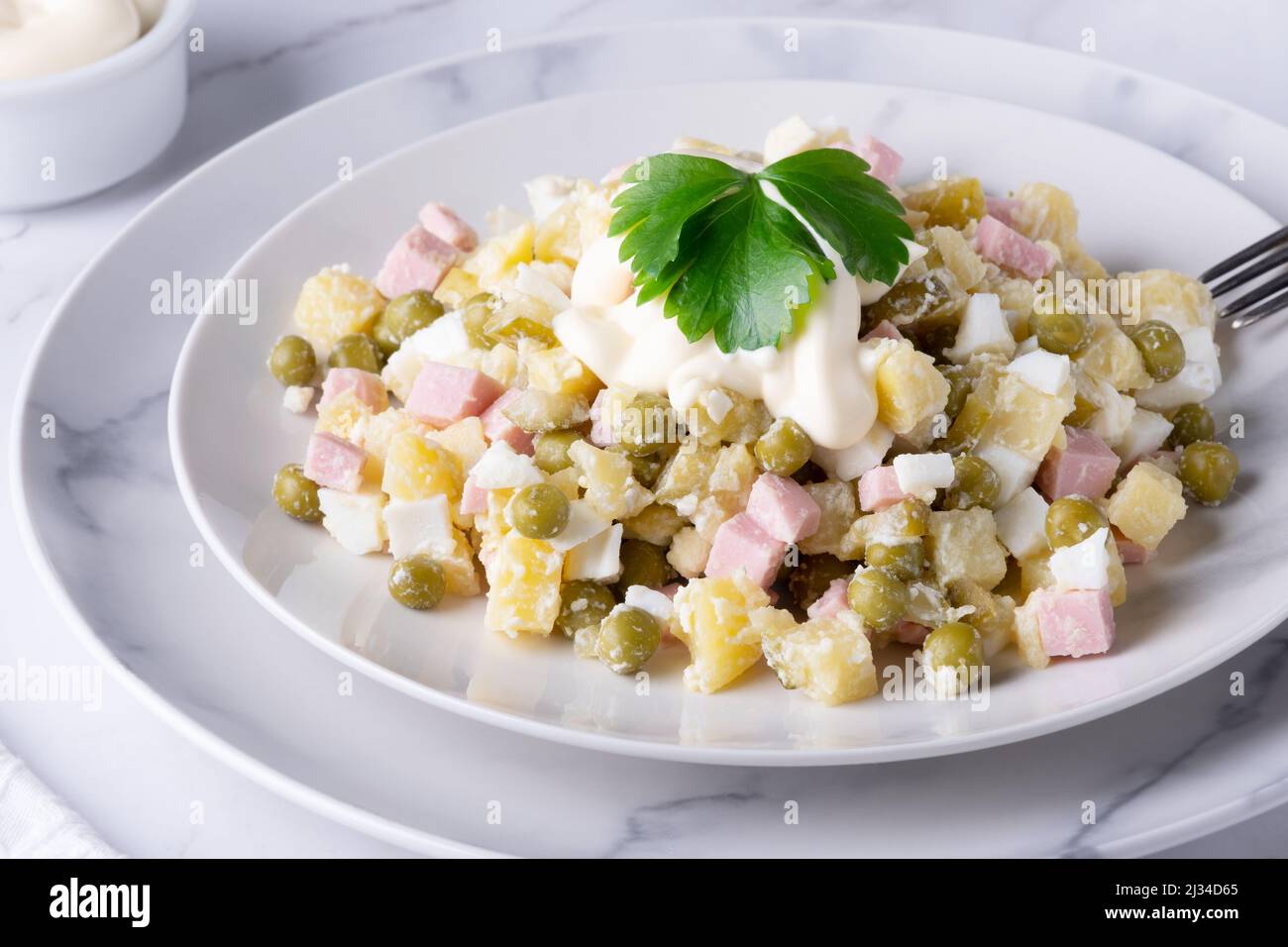 Russian olivier salad decorated with parsley Stock Photo - Alamy