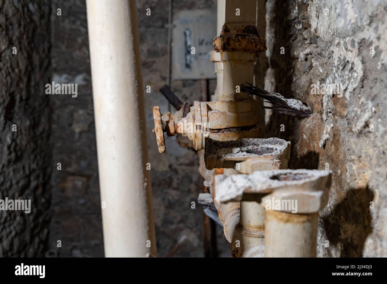 Old broken pipes for water supply or the heating in an abandoned ...