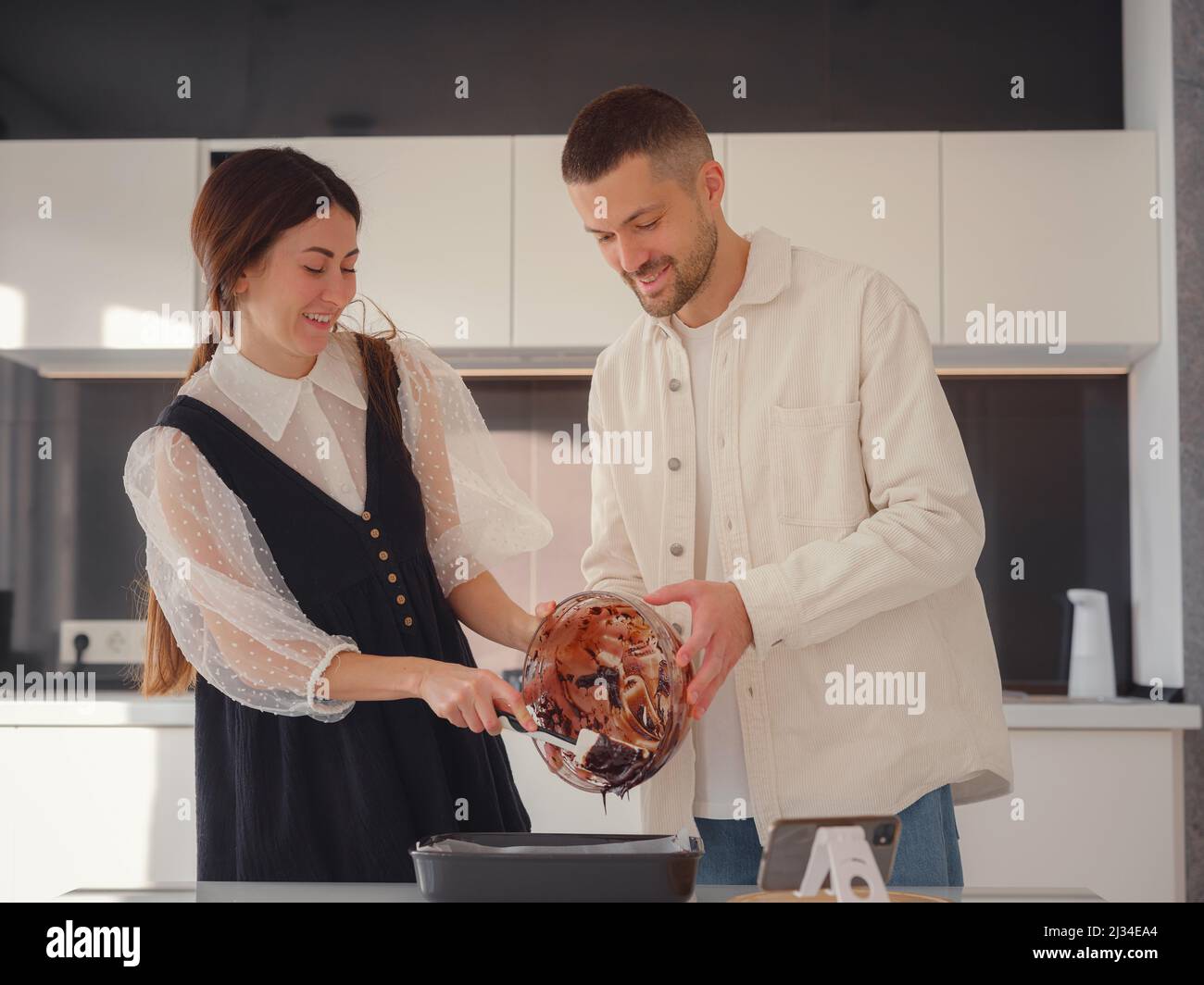 Happy young family making cake hi-res stock photography and images - Alamy