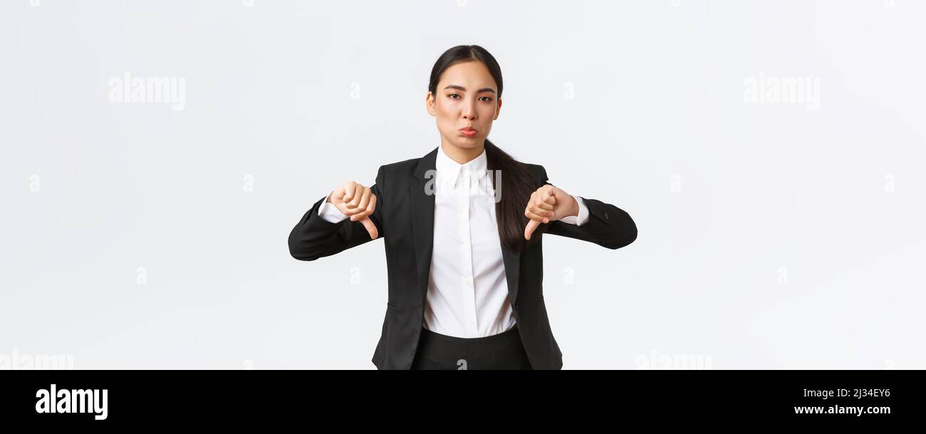 Unamused skeptical female office manager, saleswoman in black suit ...