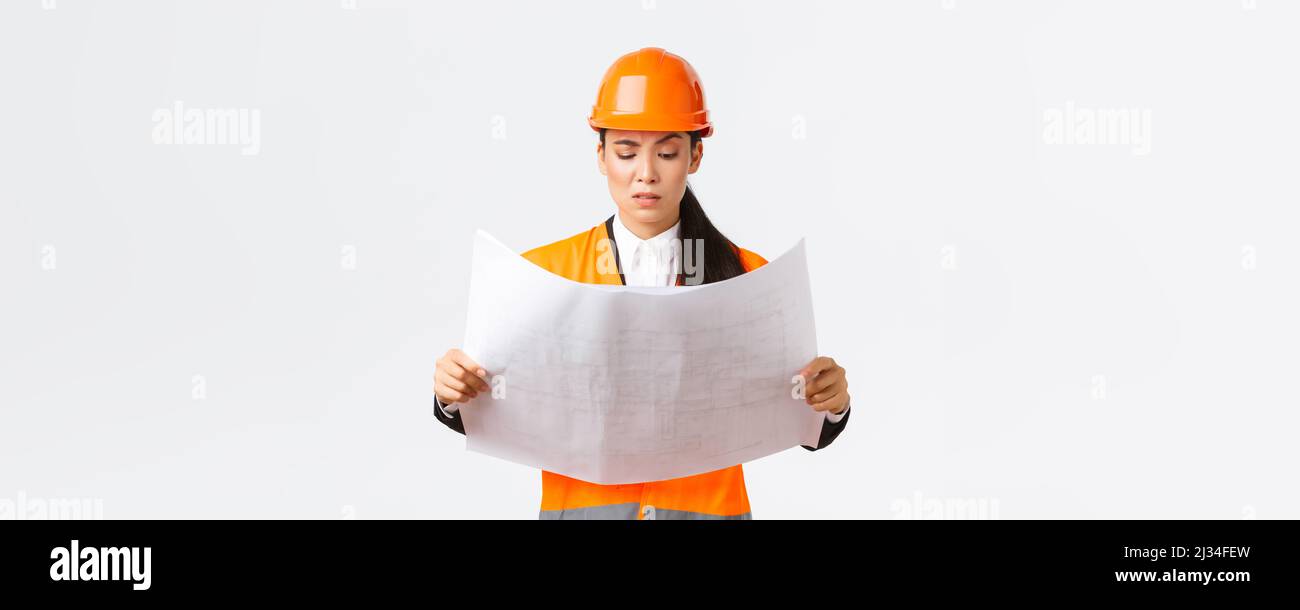 Confused and doubtful asian female chief engineer, lead architect at ...