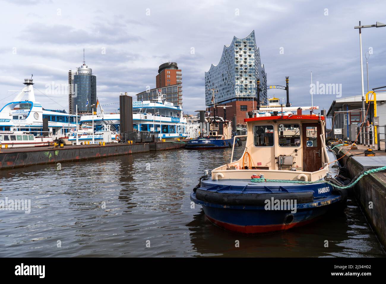 A view of boats and ships in a port and modern tall buildings in a ...