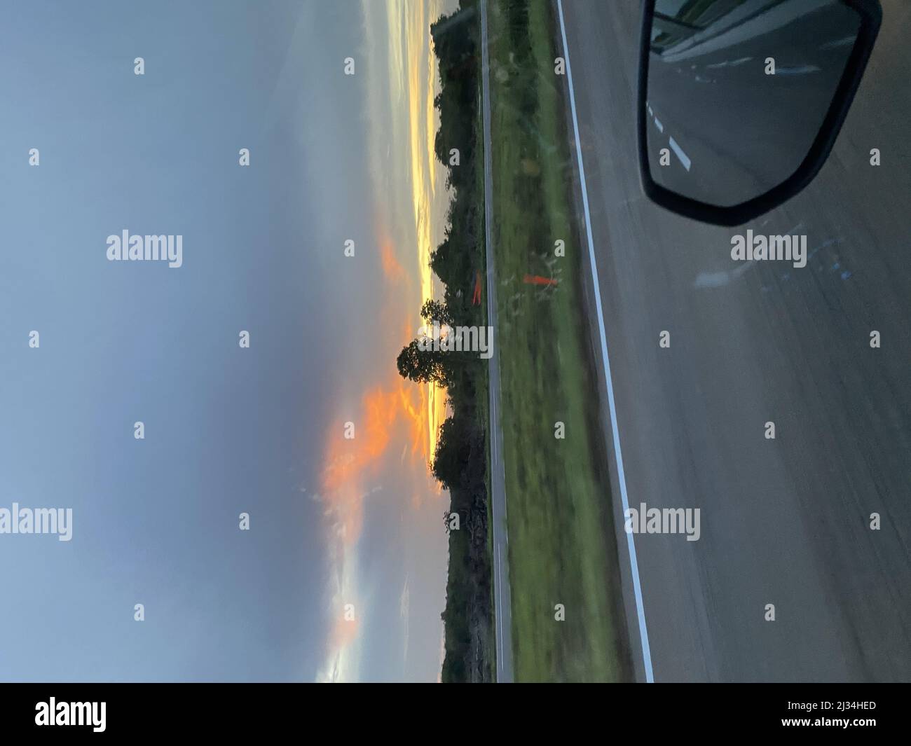 A breathtaking dark sunset sky view behind a car window Stock Photo - Alamy