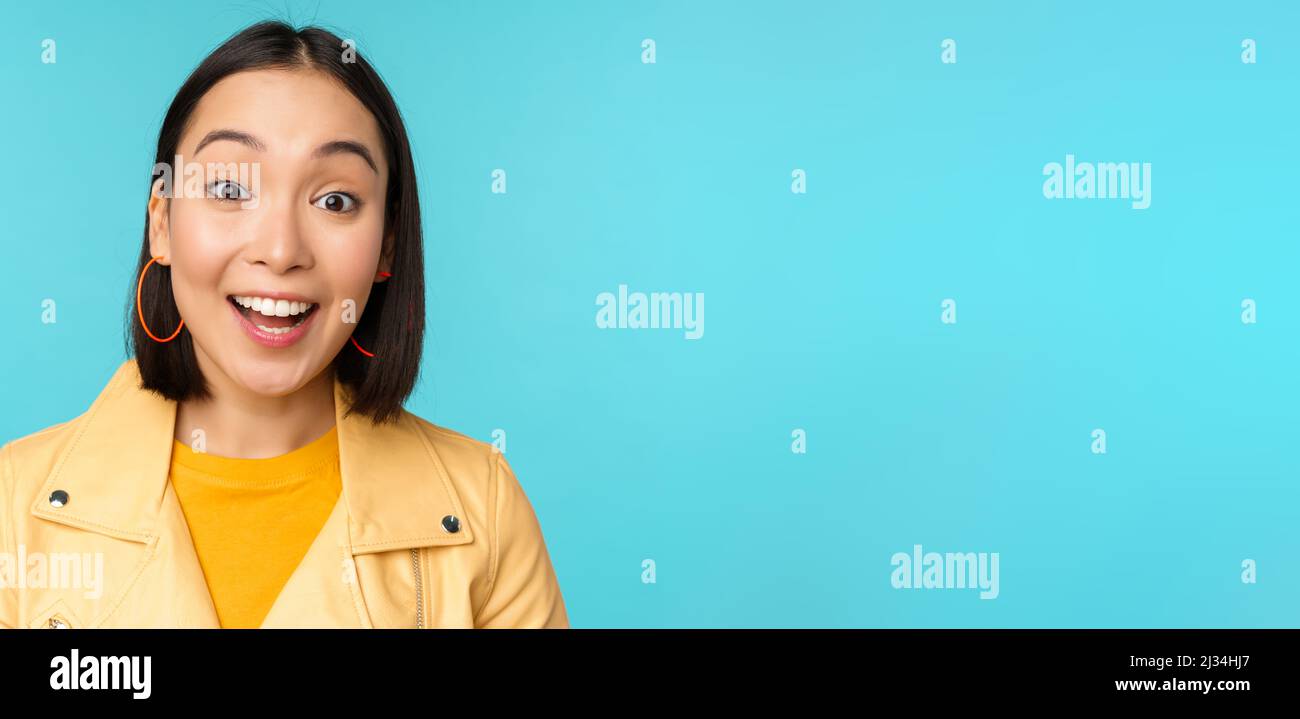 Close up portrait of natural asian girl laughing, smiling and looking ...