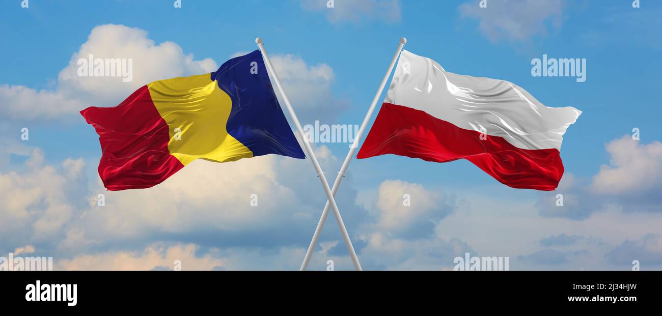 two crossed flags romania and Poland waving in wind at cloudy sky ...