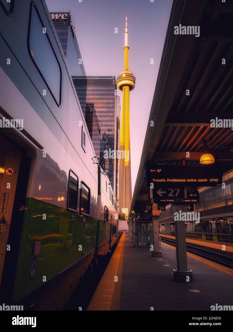 A vertical shot of the CN Tower in Toronto with a pastel sky and rustic ...