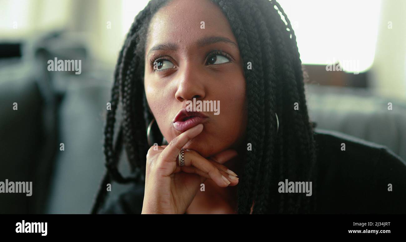 Mixed race girl thinking pondering about solution, close-up young woman ...