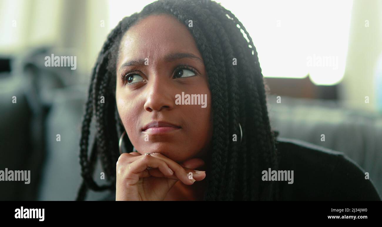 Mixed race girl thinking pondering about solution, close-up young woman ...