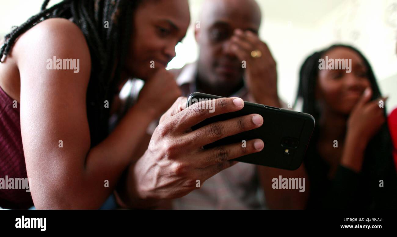Parents and children shock reaction to news on smartphone device ...