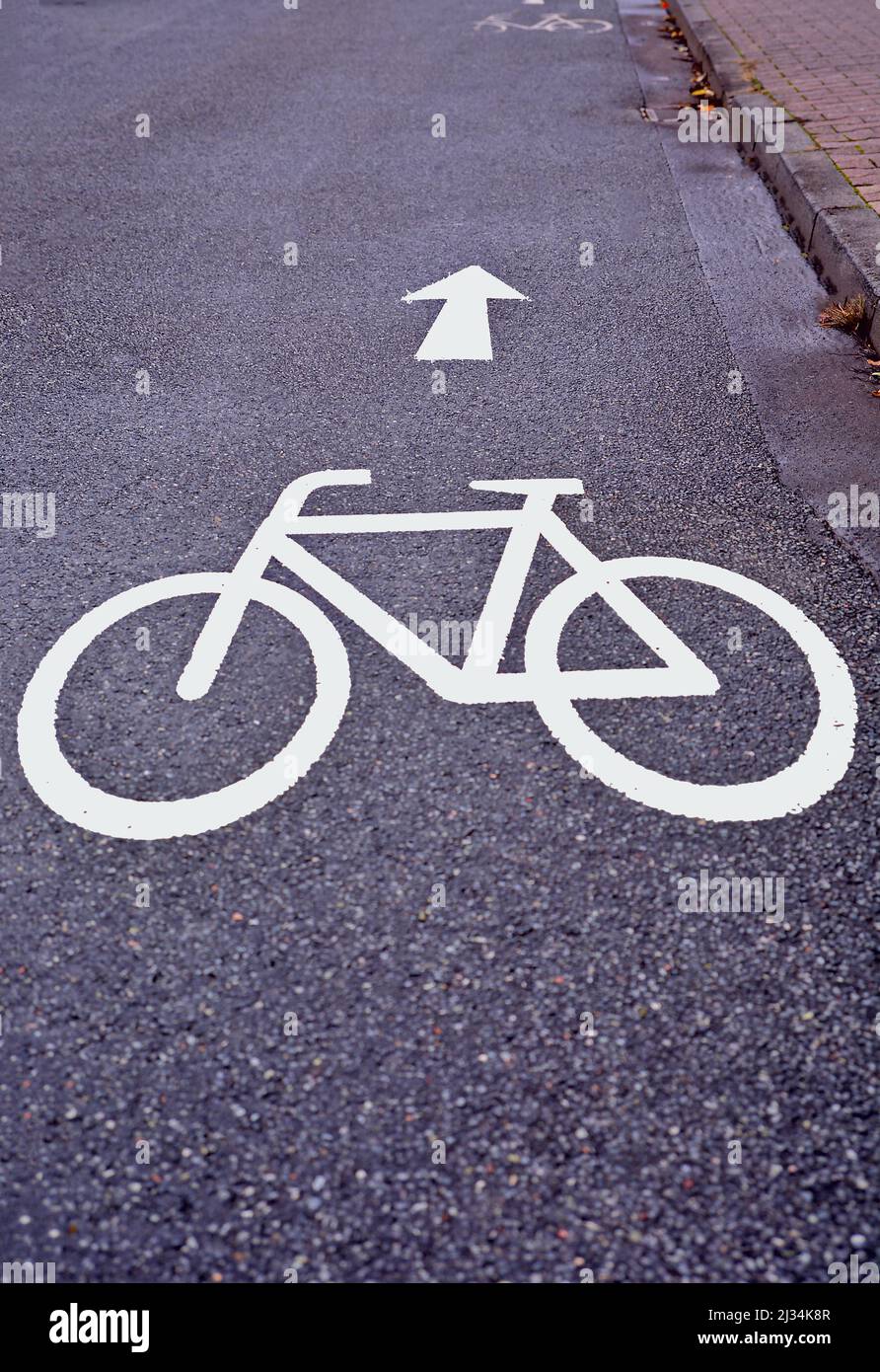 A vertical shot of a painted bicycle lane sign Stock Photo - Alamy