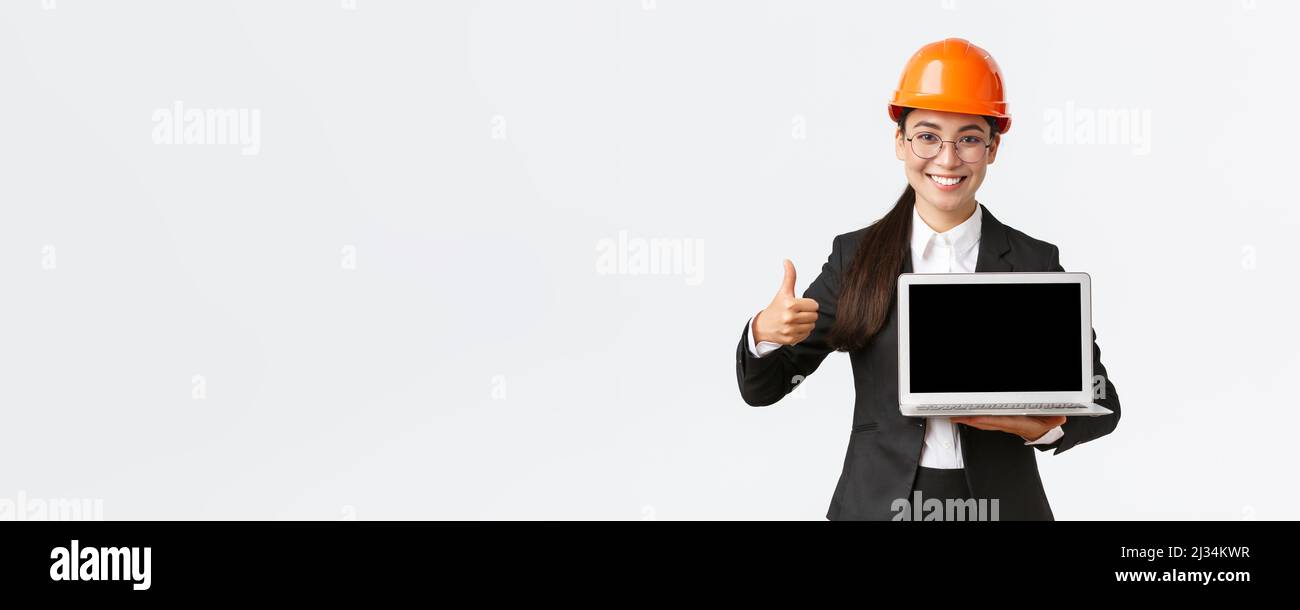 Smiling professional female architect, construction manager at factory ...