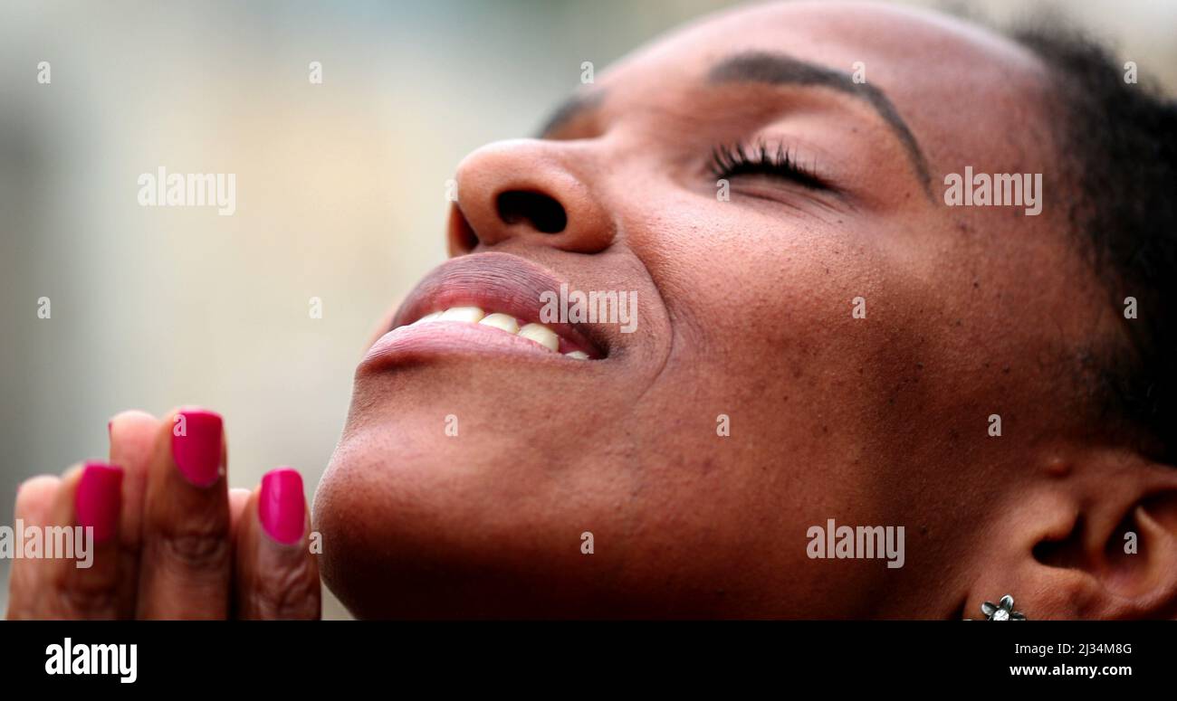 Woman praying with eyes closed, african black woman meditating Stock ...