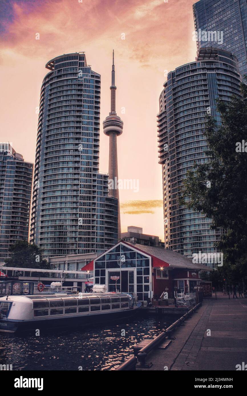A vertical shot of Toronto's CN Tower from Harbourfront with a fiery ...