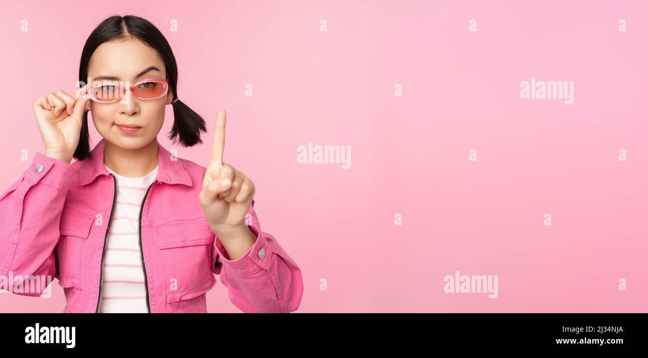 Image of asian girl with serious face, showing prohibit, scolding ...