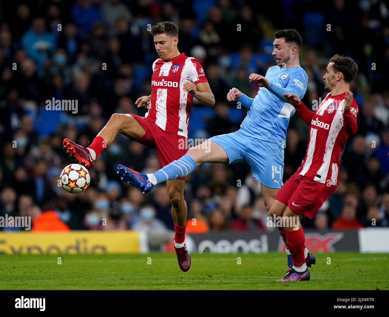 Atletico Madrid's Marcos Llorente (left) has a shot on goal under ...