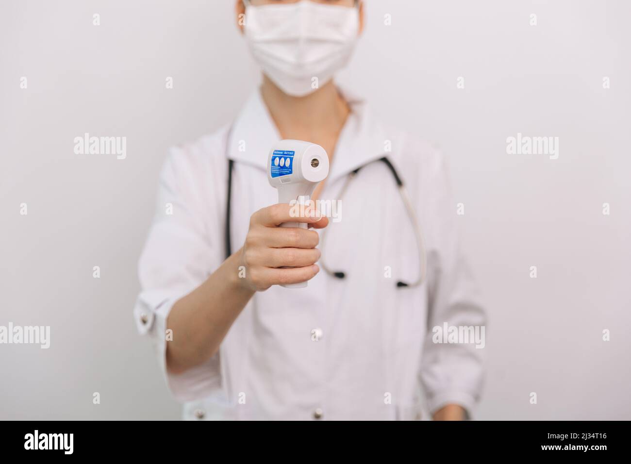 Temperature measurement gun in doctor hands. Close-up shot of doctor ...