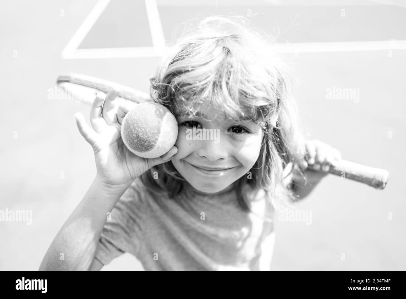 Child playing tennis on outdoor court. Little girl with tennis racket ...