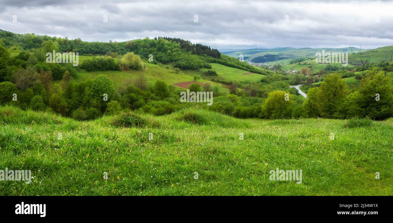 rural landscape on a rainy day in mountains. village in the distant ...