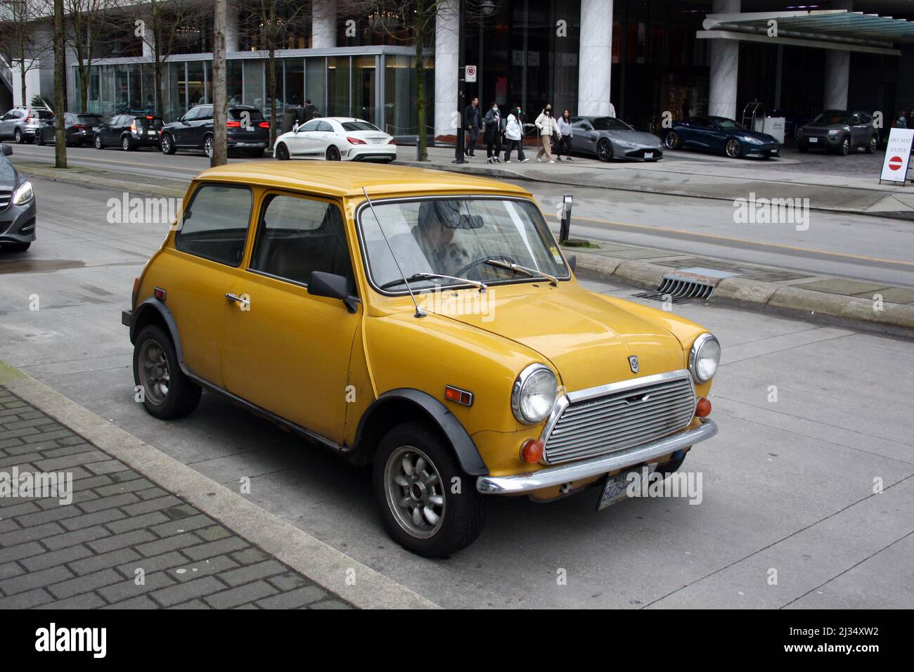 A yellow Mini Cooper car in downtown Vancouver, British Columbia ...