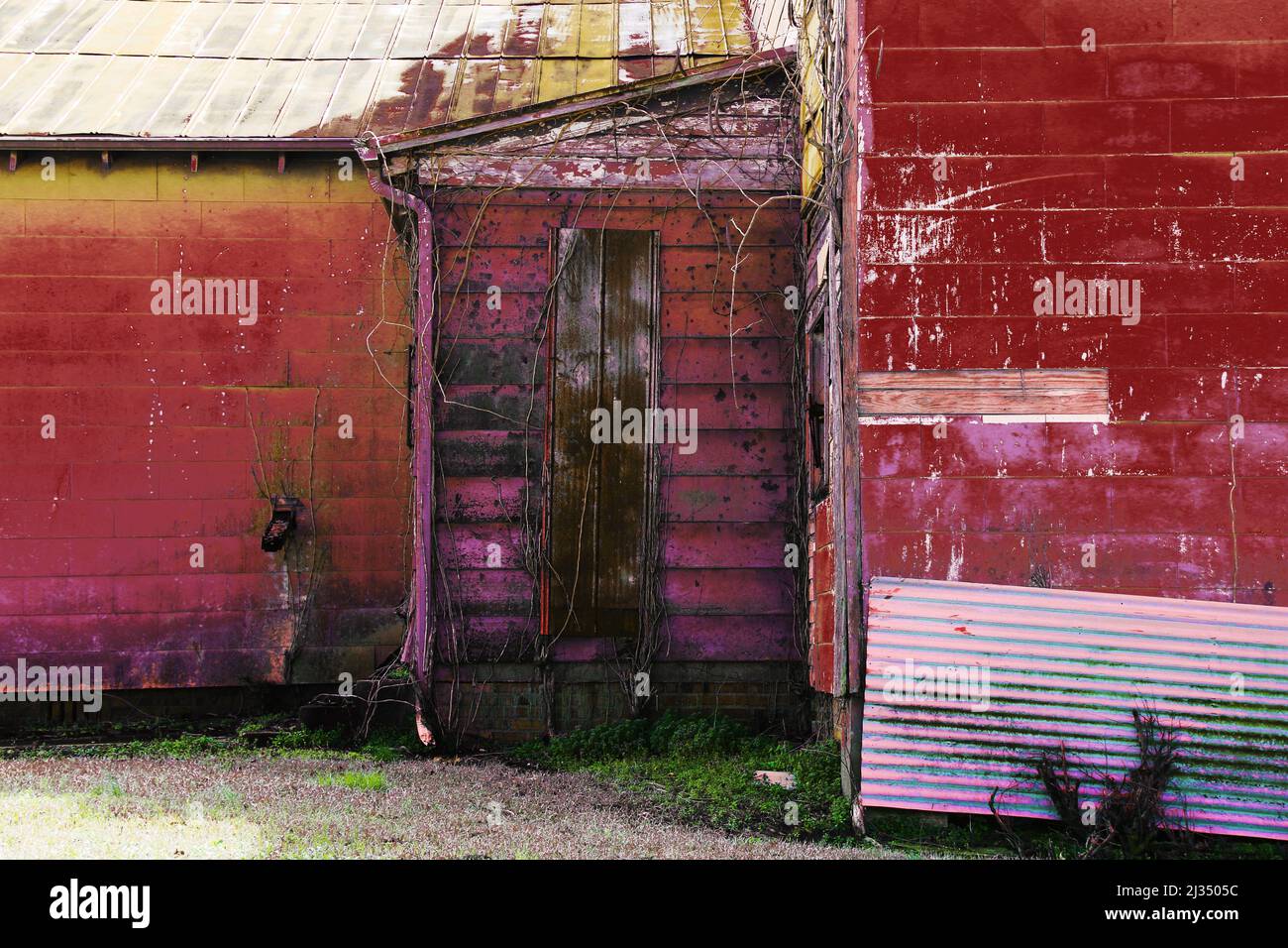 a rusted red painted old abandoned war zone damaged house building city ...