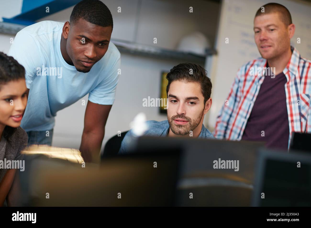 Design is what we do. Shot of team of colleagues using a computer ...