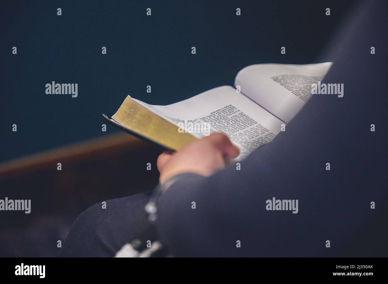 A closeup of a man hand holding the Holy Bible Stock Photo - Alamy