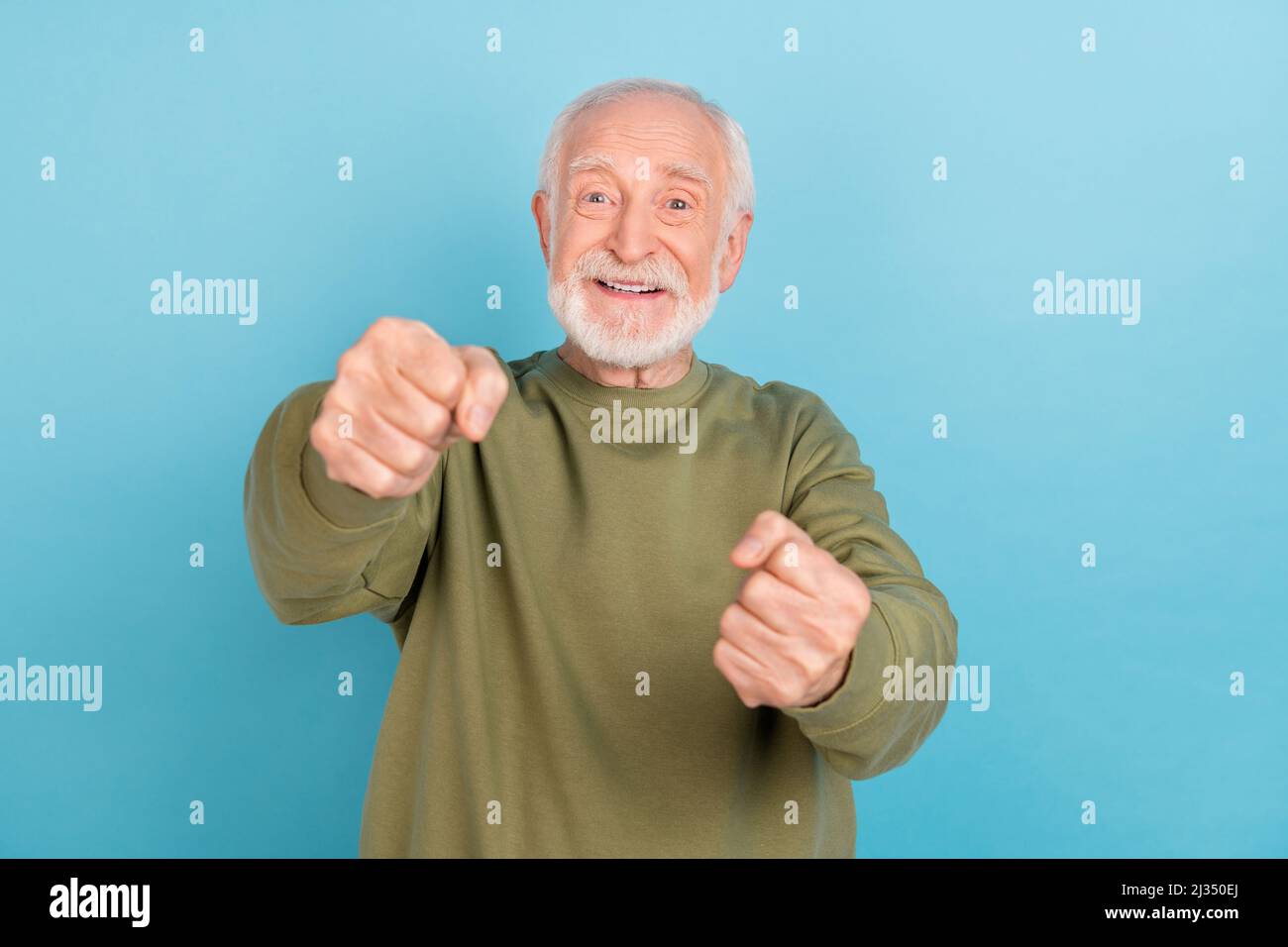 Portrait of attractive cheerful funny grey-haired man driving invisible ...