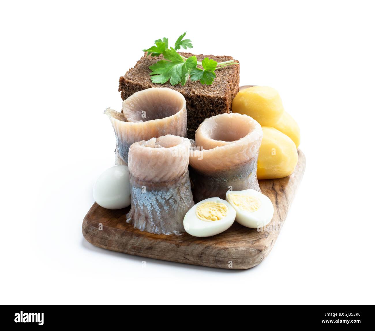 Homemade marinated herring roll with rye bread and baby potato with ...