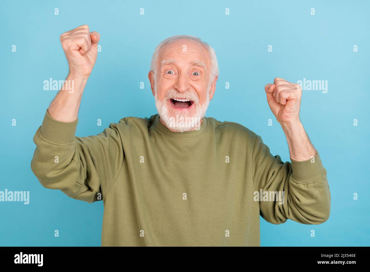 Portrait of attractive cheerful grey-haired man rejoicing having fun ...