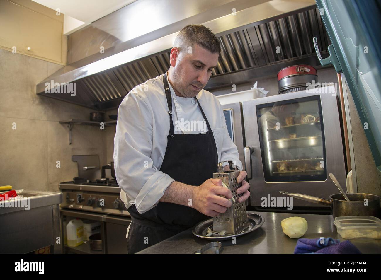 Restaurant chef grating cheese hi-res stock photography and images - Alamy