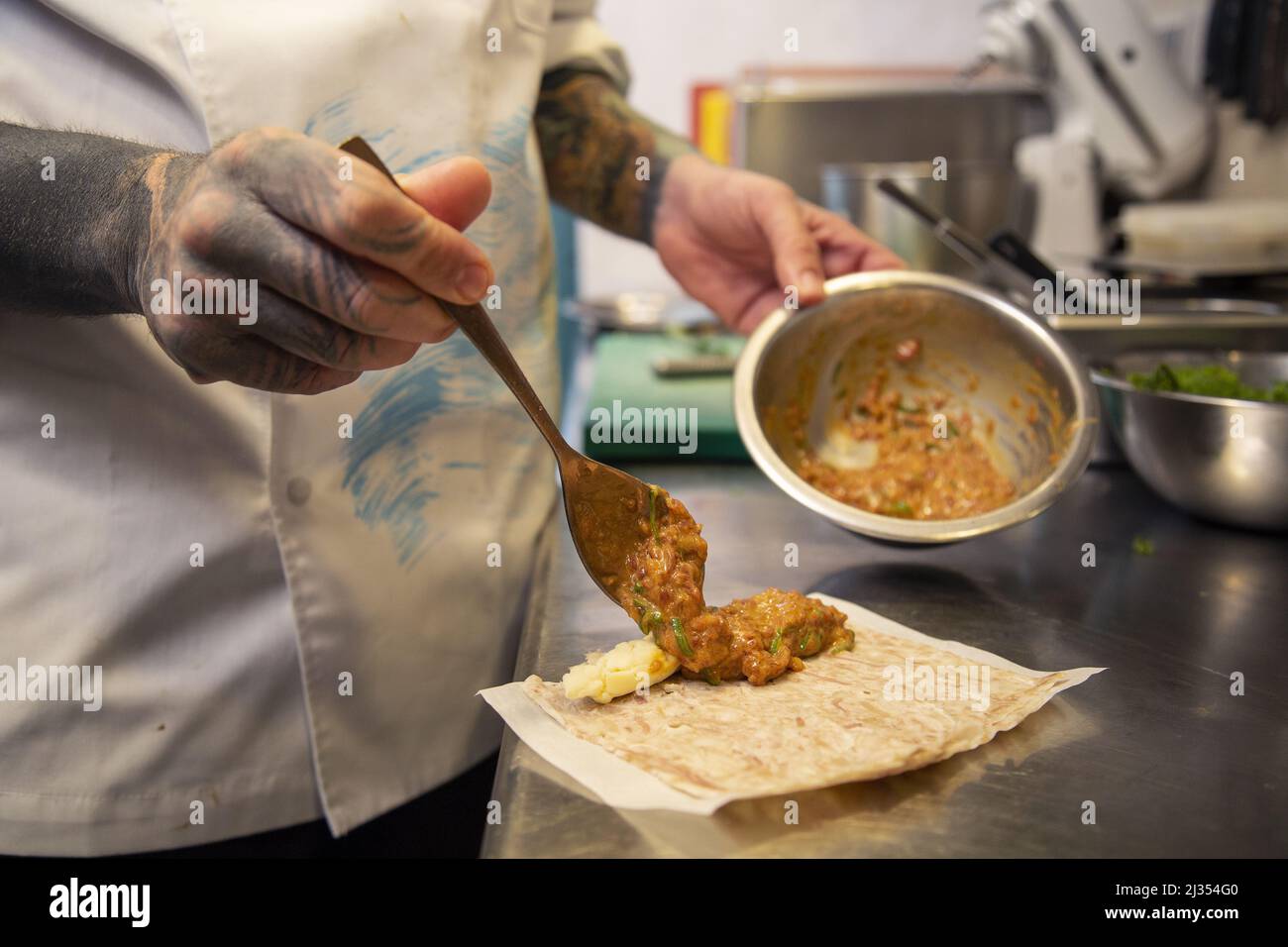 A chef cooking food at a restaurant kitchen Stock Photo - Alamy