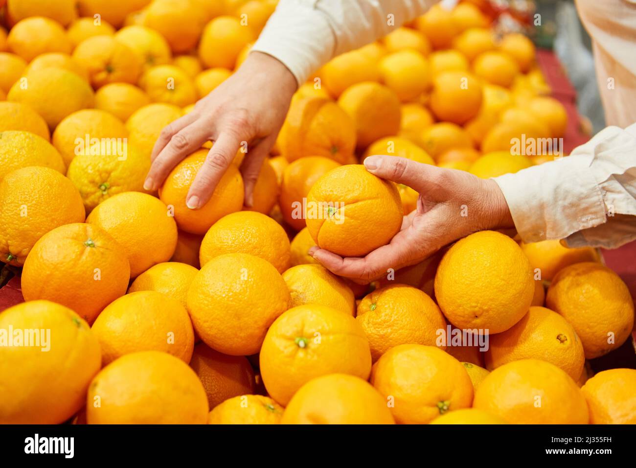 Customer at the fruit and vegetable stand in the supermarket shopping ...