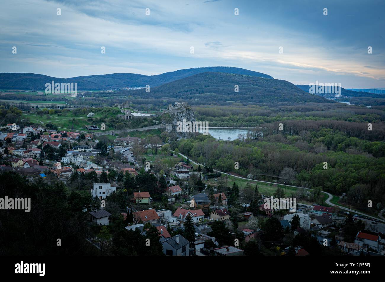 An aerial view of a landscape with buildings surrounded by mountains in ...