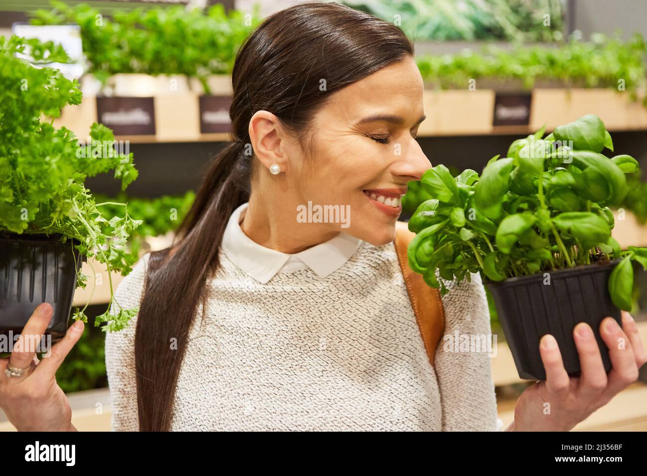 Woman smelling basil hi-res stock photography and images - Alamy