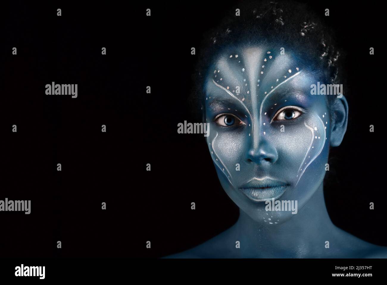 Portrait of beautiful African girl with blue tribal paintings ...