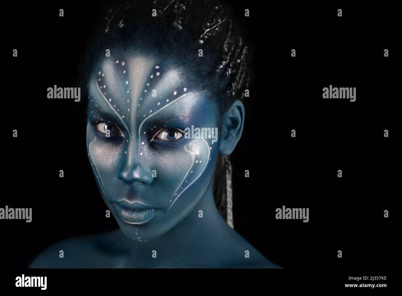 Portrait of beautiful African girl with blue tribal paintings ...