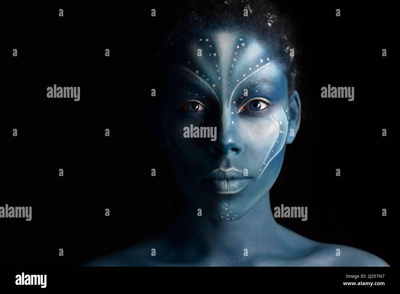 Portrait of beautiful African girl with blue tribal paintings ...