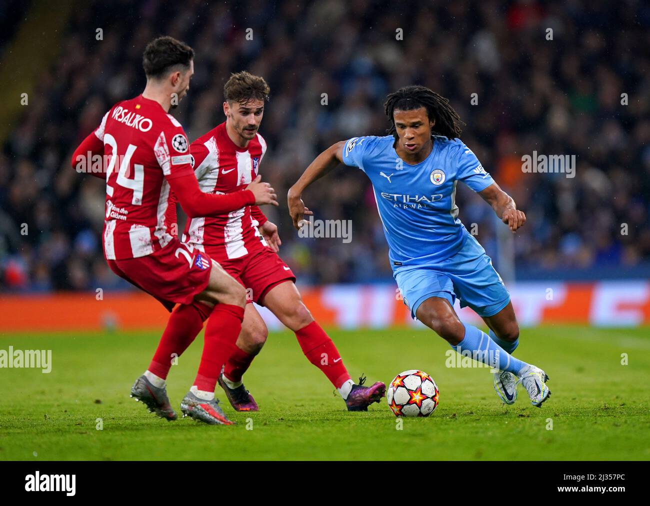 Manchester City's Nathan Ake (right) battles for the ball against ...