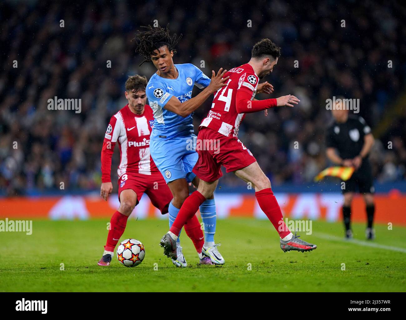 Manchester City's Nathan Ake (centre) battles for the ball against ...