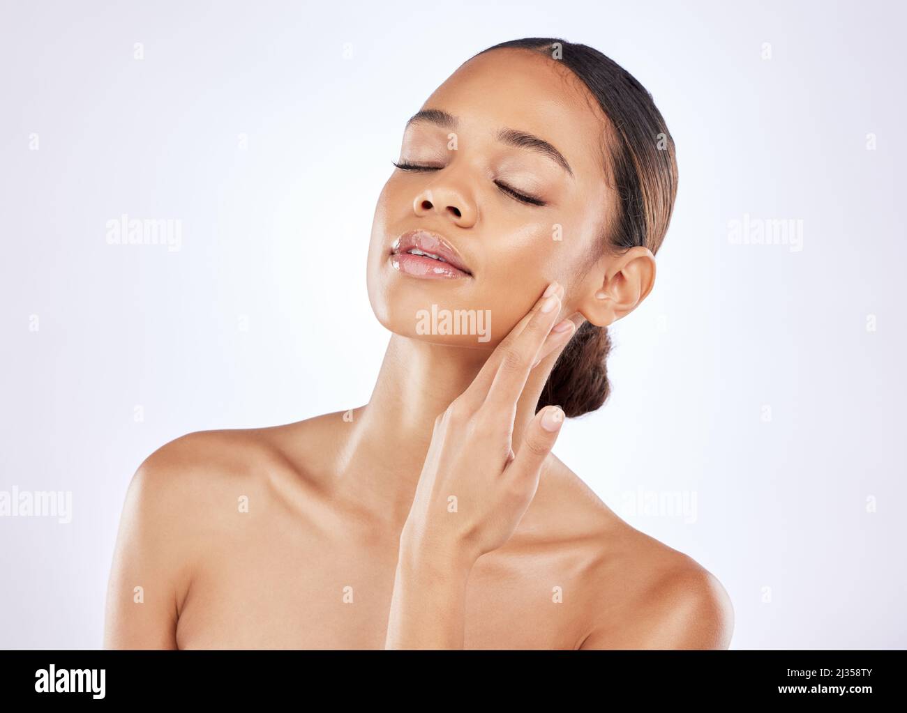 Feeling fulfilled within myself. Shot of a young woman posing against a ...
