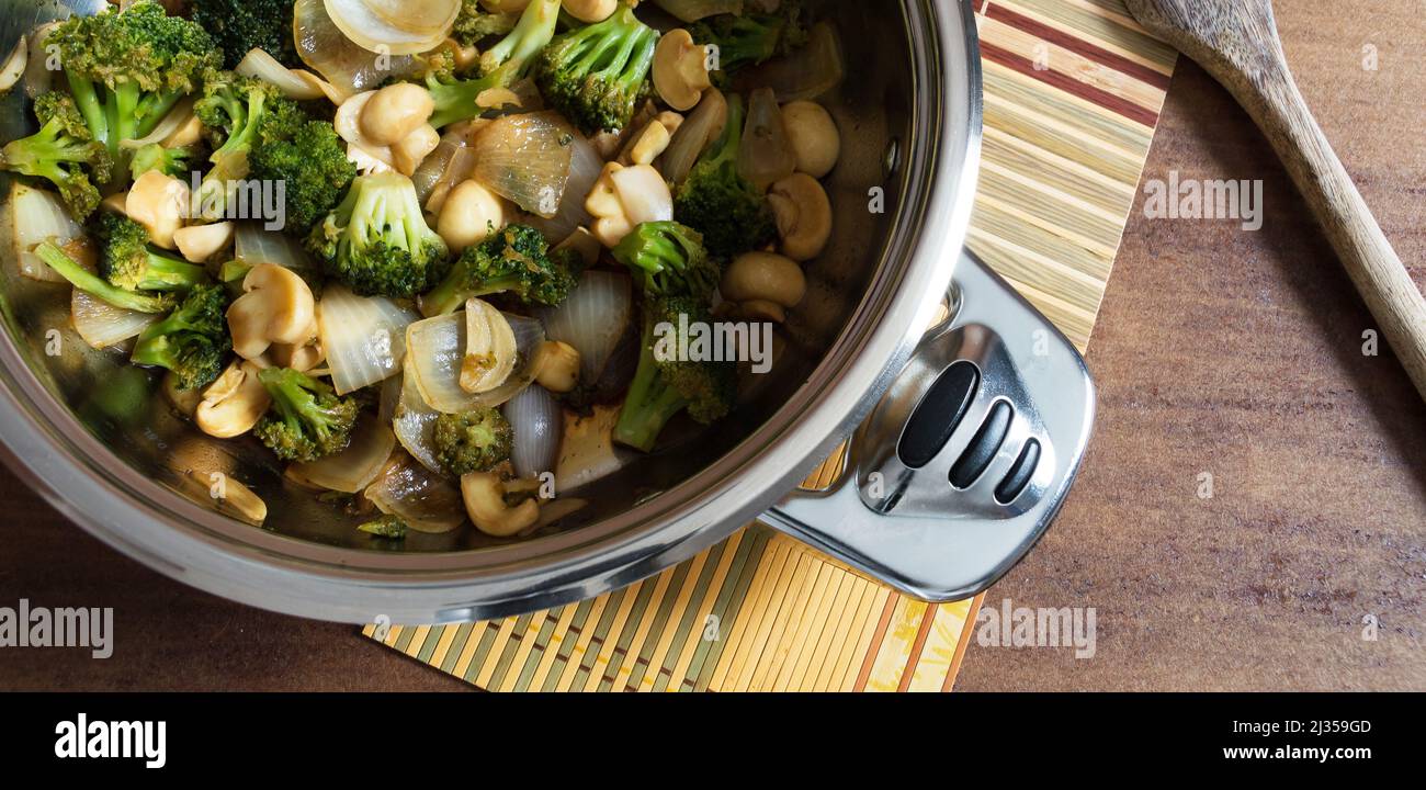 Image made from above of a frying pan with broccoli sautéed, mushrooms ...