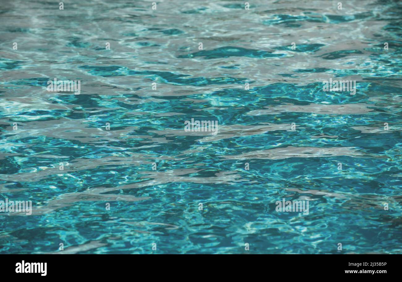Background of blue water in swimming pool with sun reflection, ripple ...