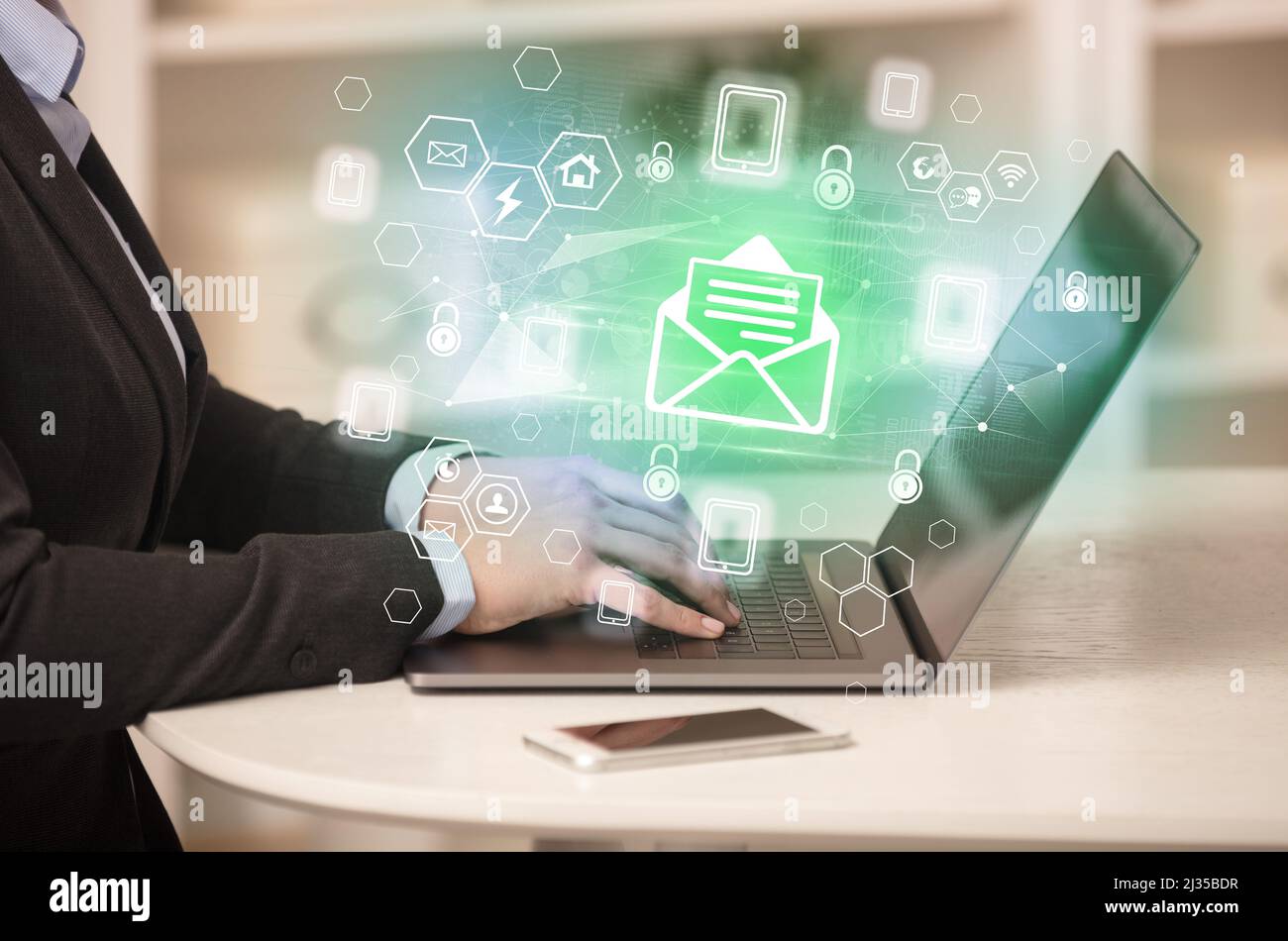 Hands working on laptop with digital icons Stock Photo - Alamy