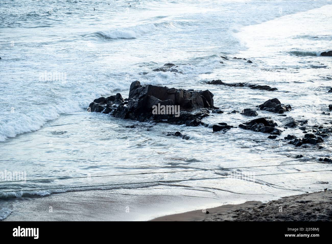 Sea waves breaking on the beach rocks. Salvador, state of Bahia, Brazil ...