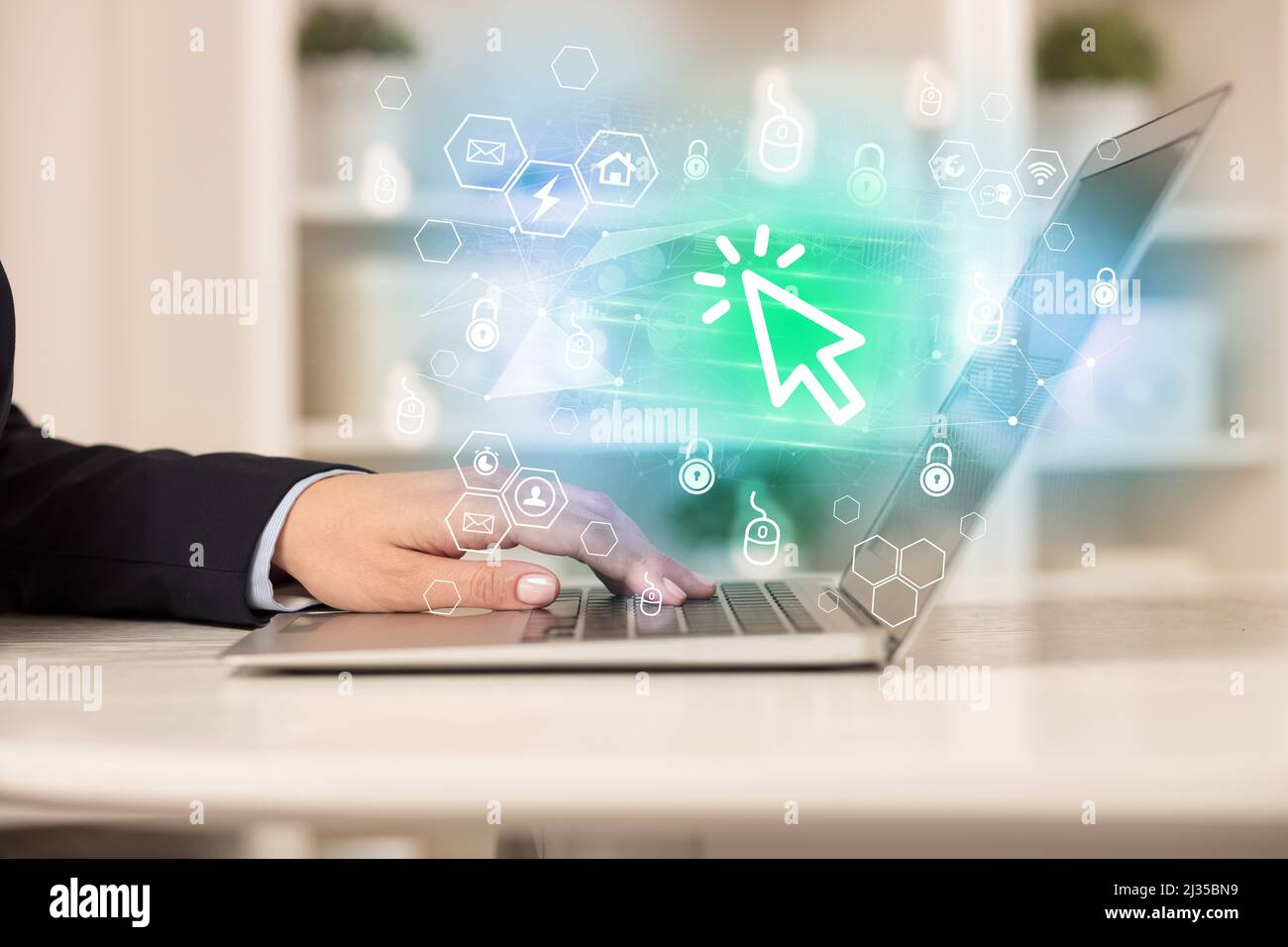 Hands working on laptop with digital icons Stock Photo - Alamy