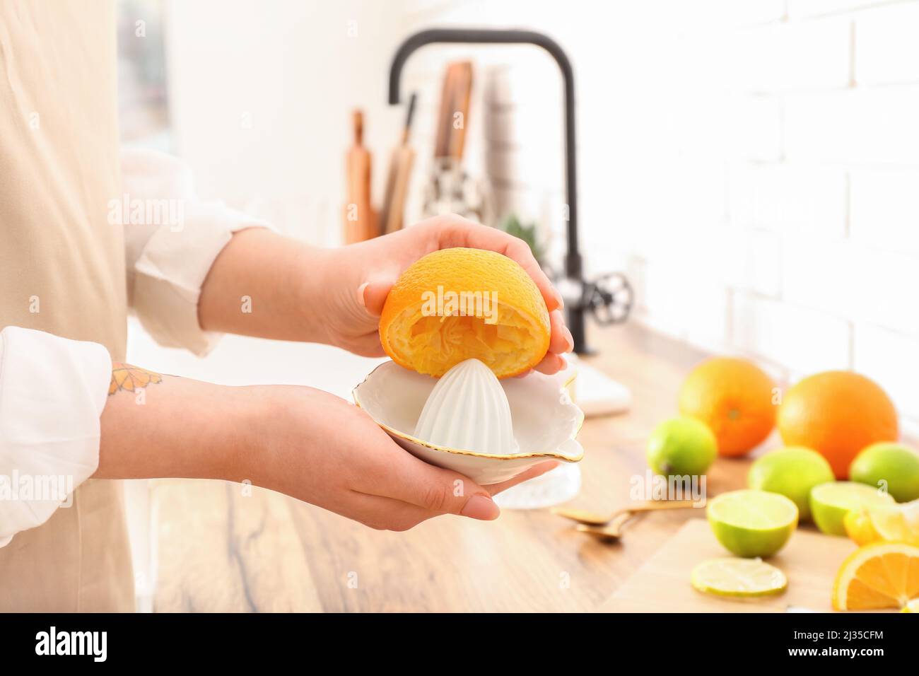 Woman squeezer squeezing orange juice hi-res stock photography and ...