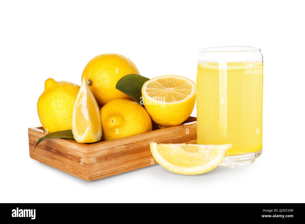 Wooden box with fresh lemons and glass of juice on white background ...