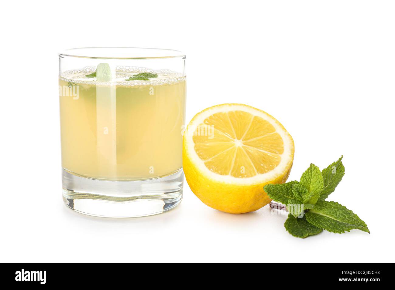 Glass with fresh lemon juice on white background Stock Photo - Alamy
